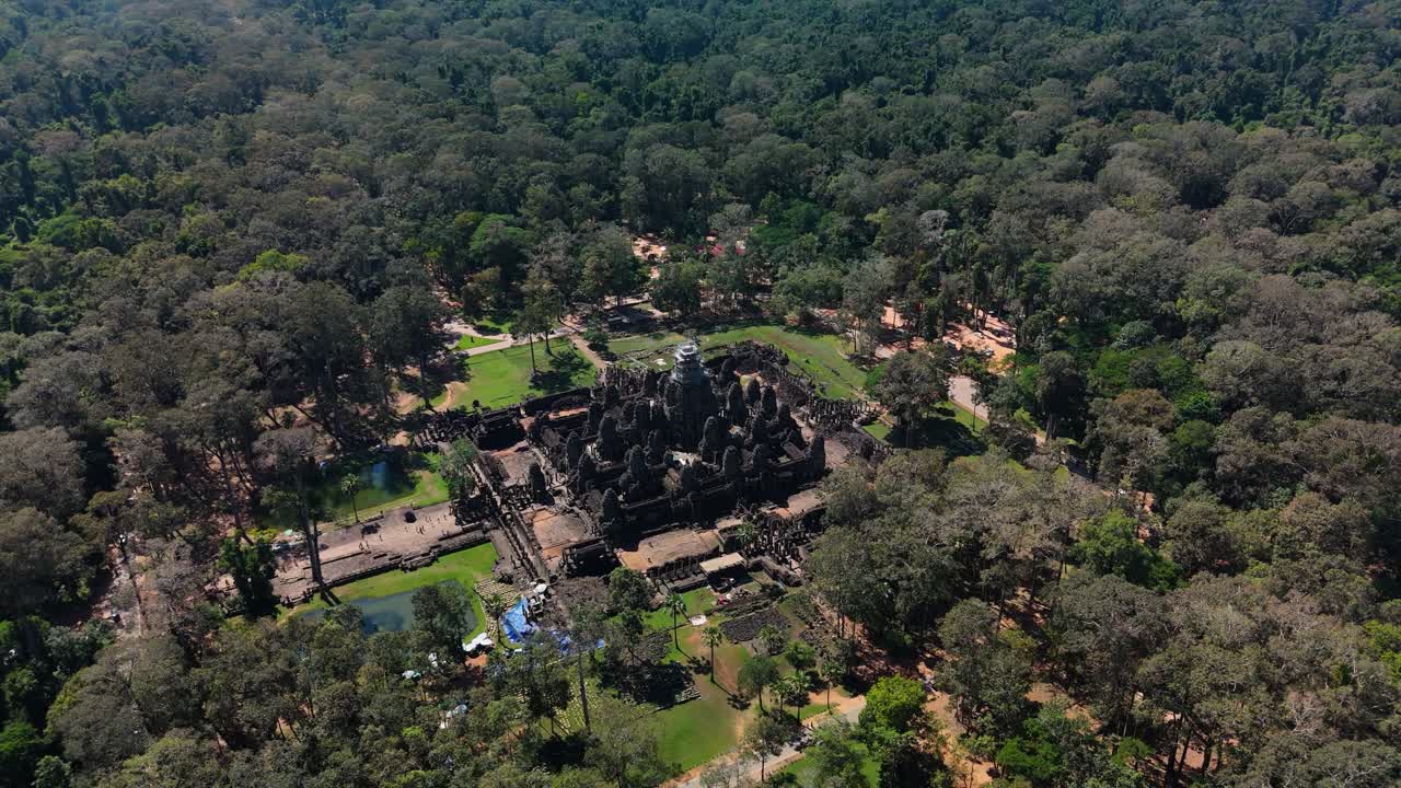A high-altitude aerial orbit left reveals Bayon Temple surrounded by ...