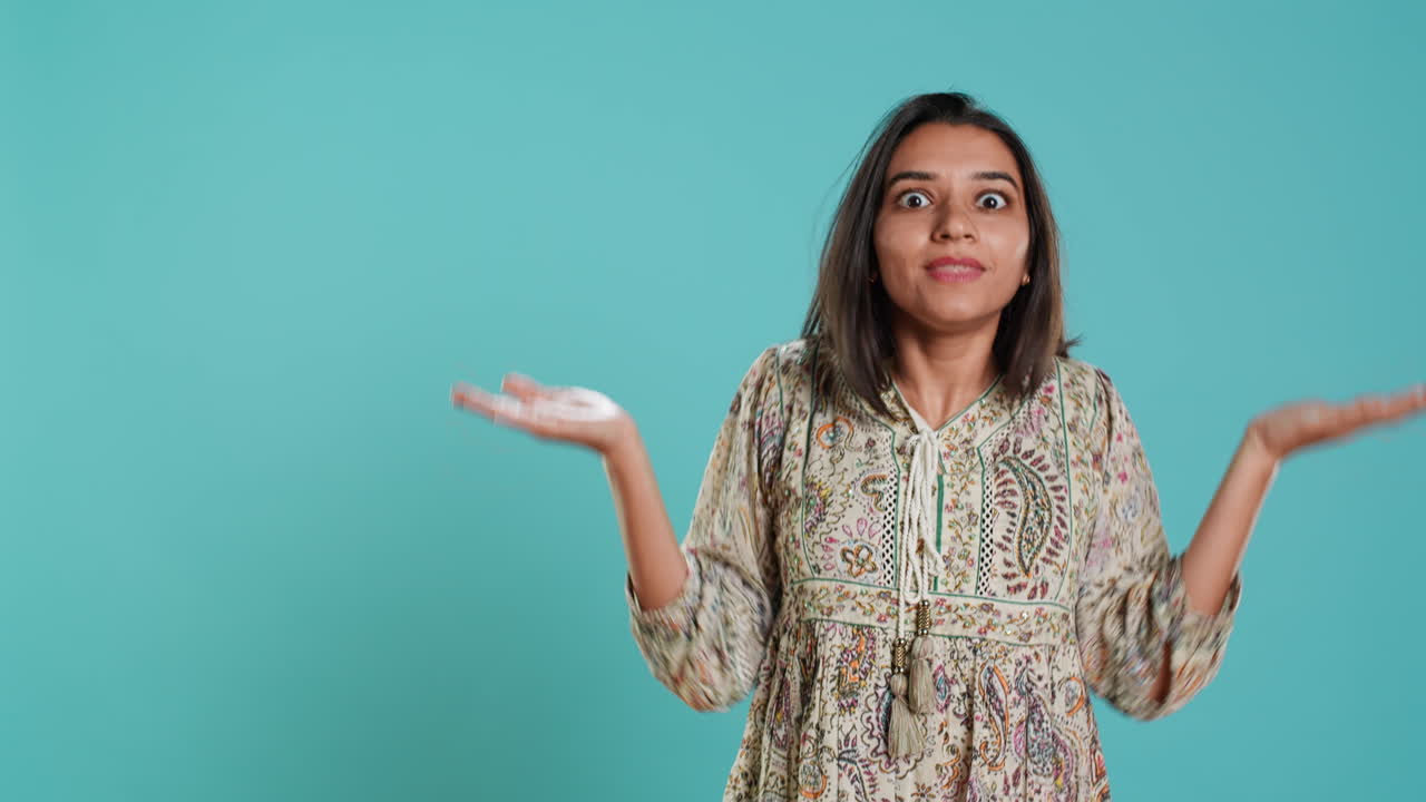 Premium stock video - Woman shrugging shoulders, unable to provide answer