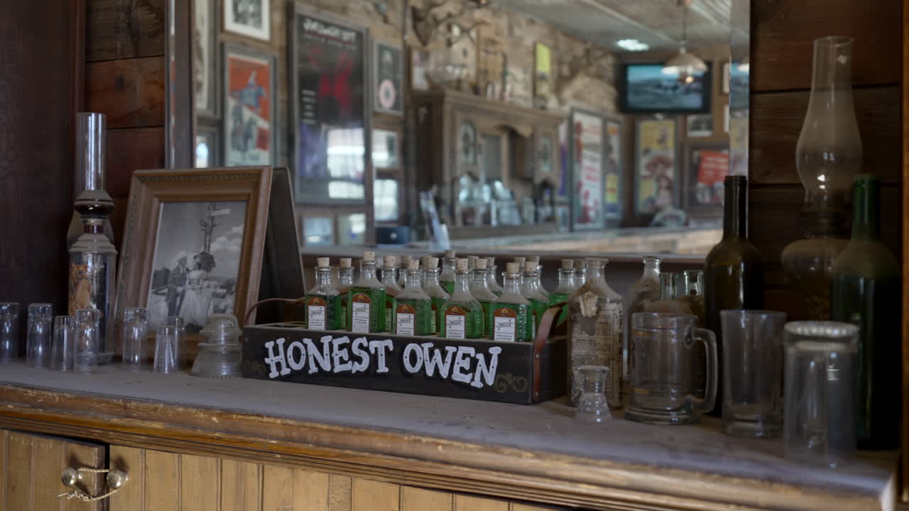 Interior of an empty western saloon with antique glass bottles and ...