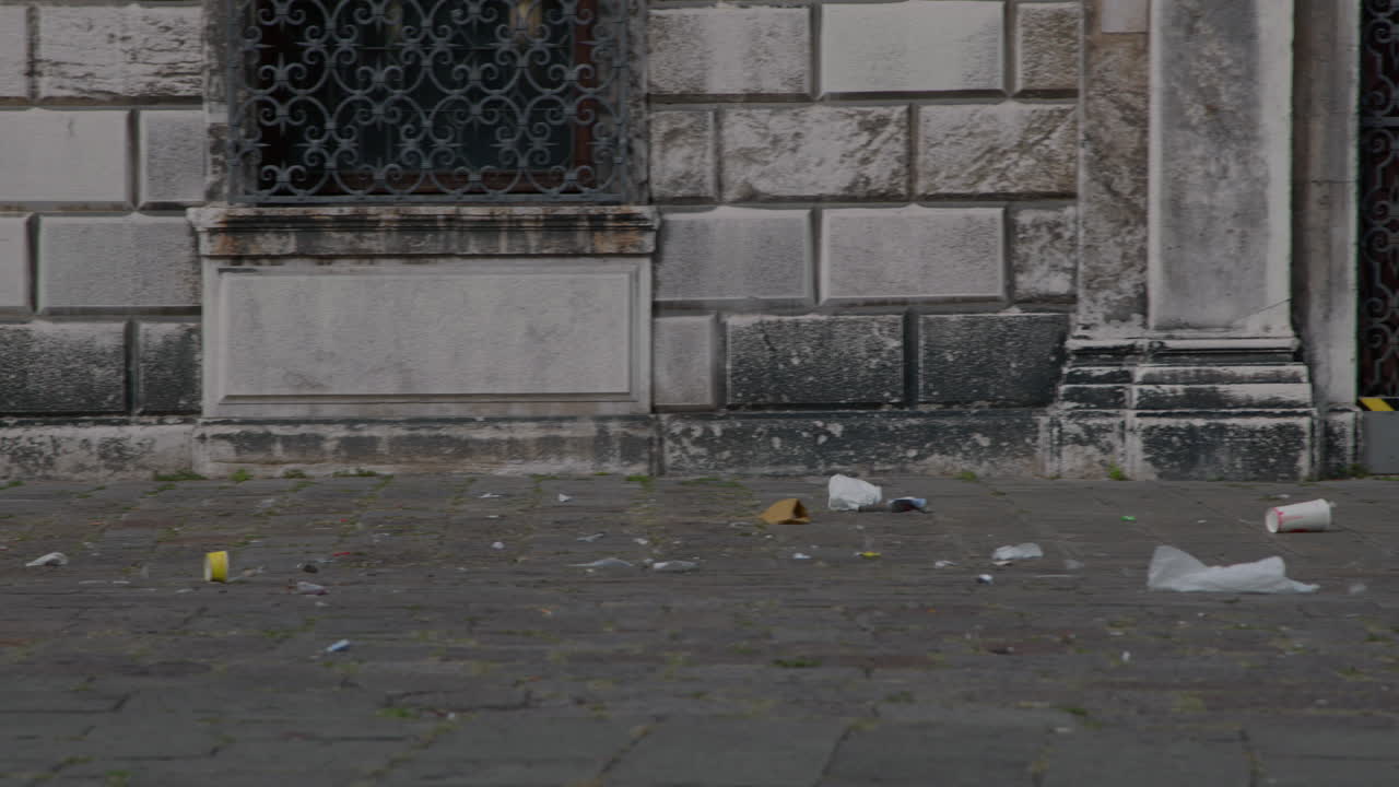 Litter on the street in front of a building Premium Stock Video Footage