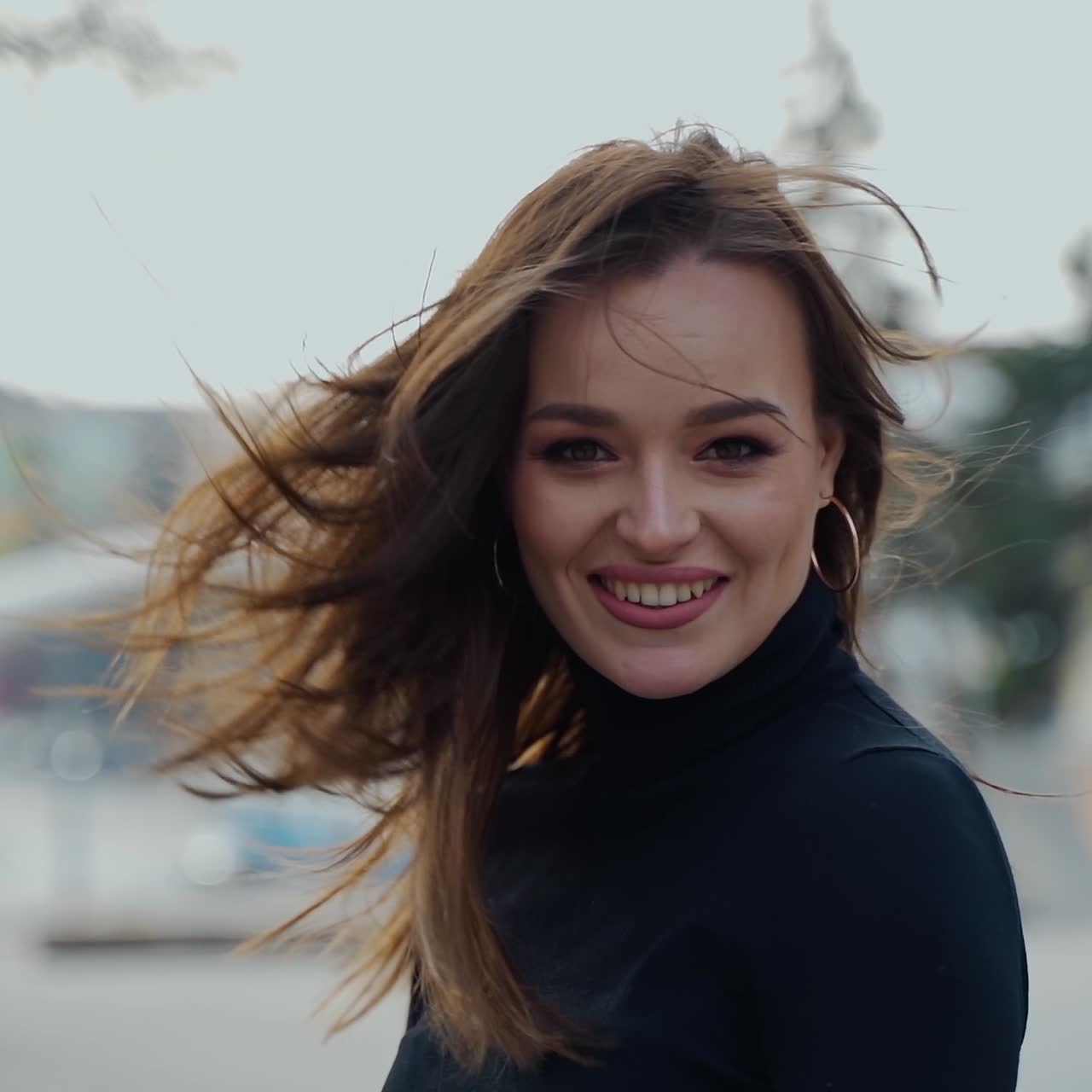 Happy girl turning around in the park. Attractive young lady with long ...