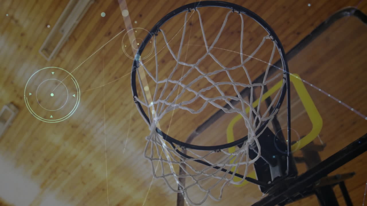 Premium stock video - Basketball hoop with net and data processing animation over wooden background