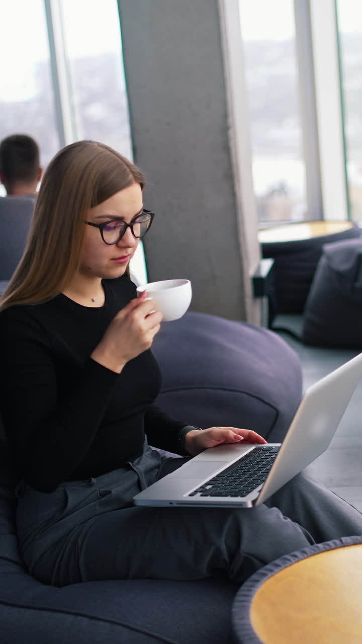 Beautiful lady in office near the window. Attractive young business ...