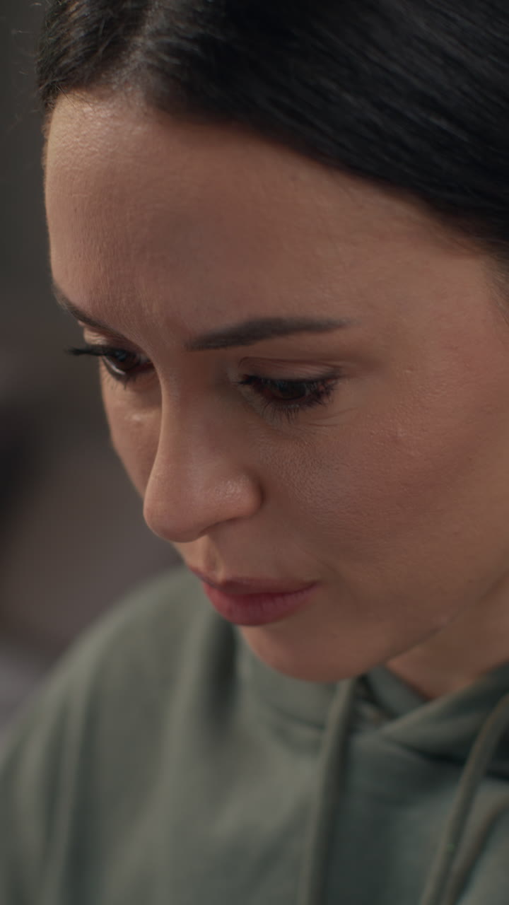 Free stock video - Vertical video close up on face of anxious woman sitting indoors on sofa ...