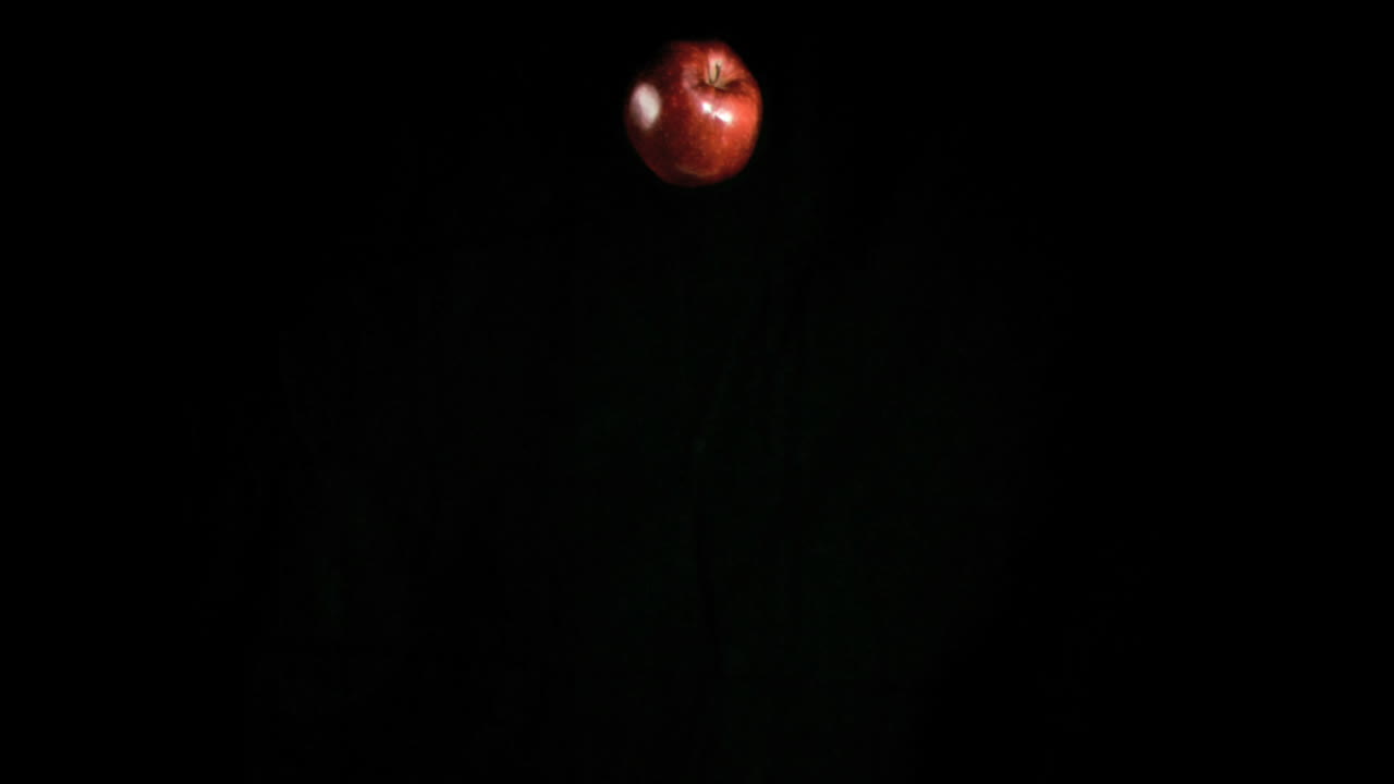 Premium stock video - Red apple falling in super slow motion