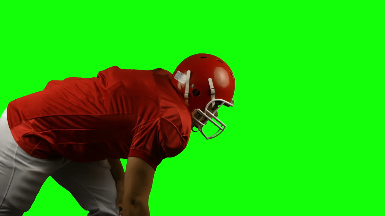 Premium stock video - Red american football player squatting