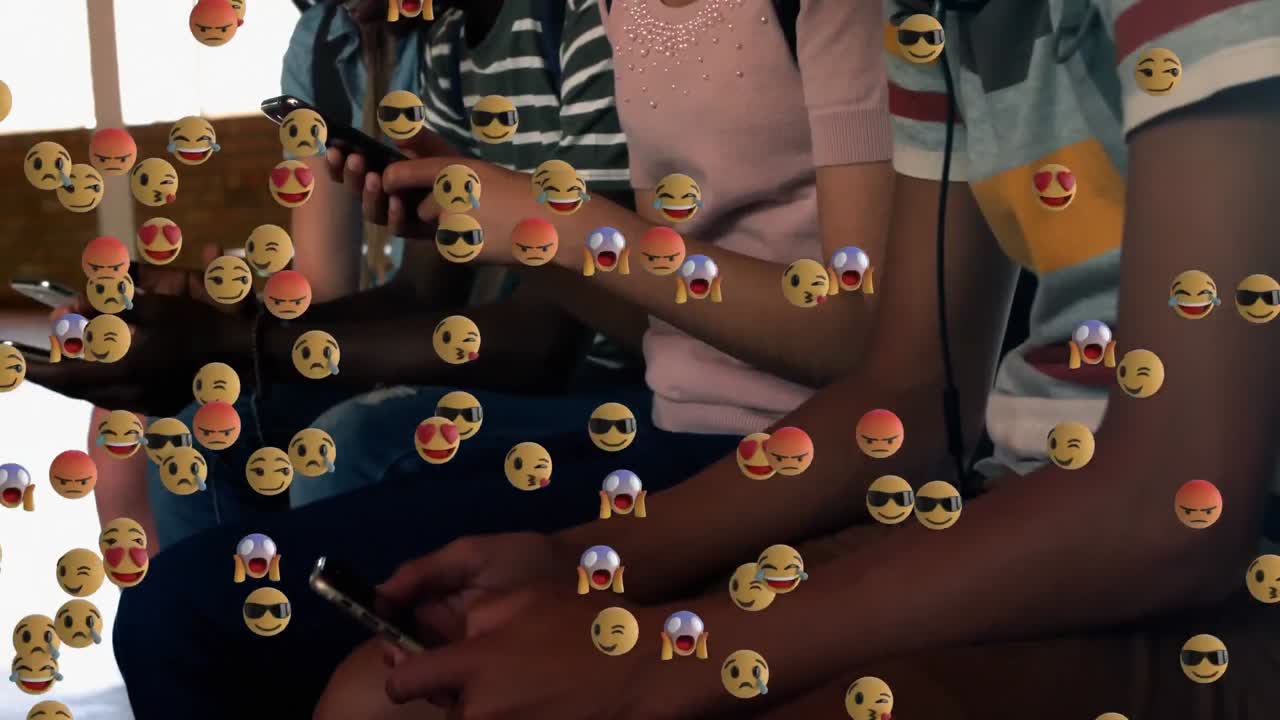 Multiple Face Emojis Floating Against Group Of Students Using ...
