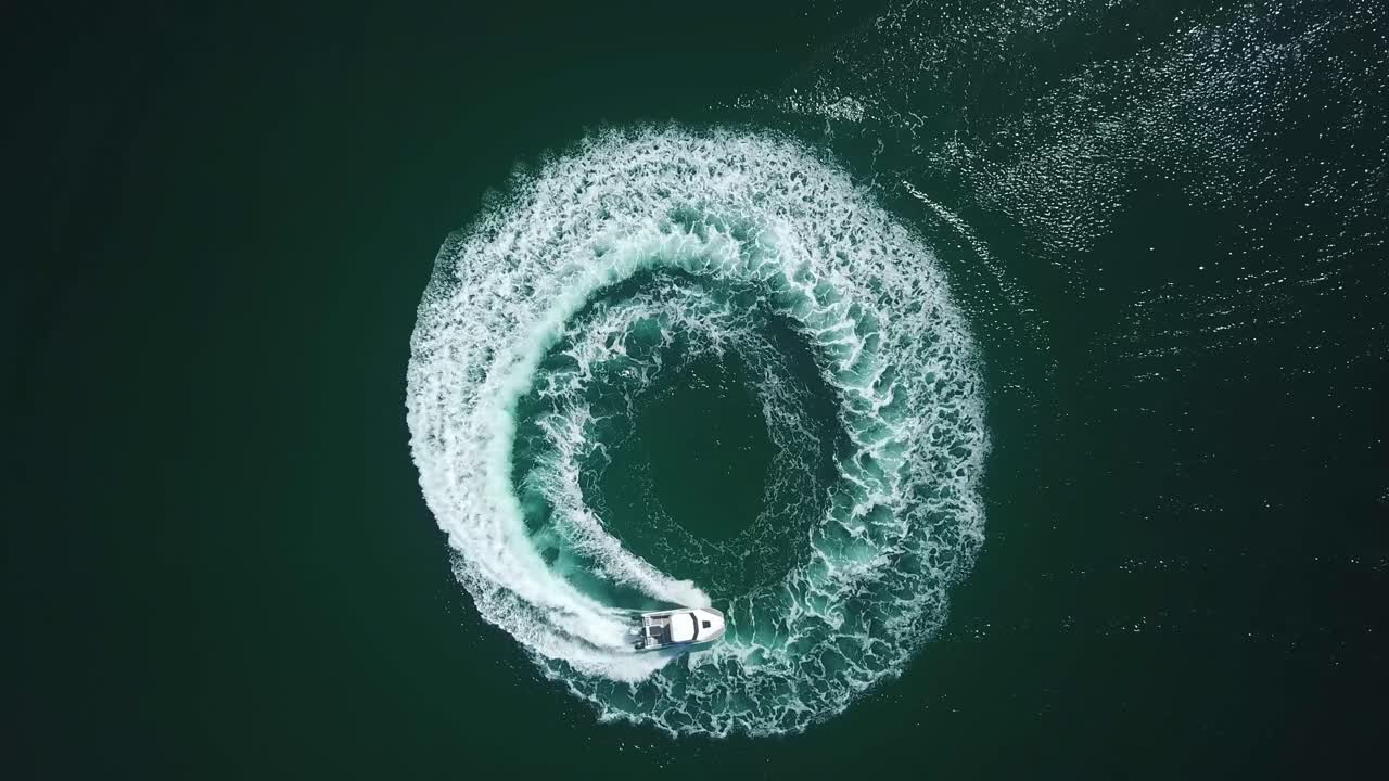 Aerial Bird View Of A Speedboat Riding In A Circle And Making Beautiful ...
