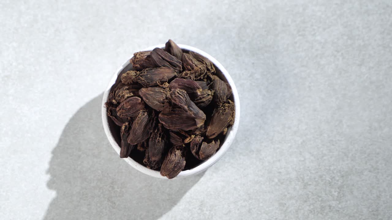Premium stock video - Black cardamom - kali ilayachi - badi elaichi is ...