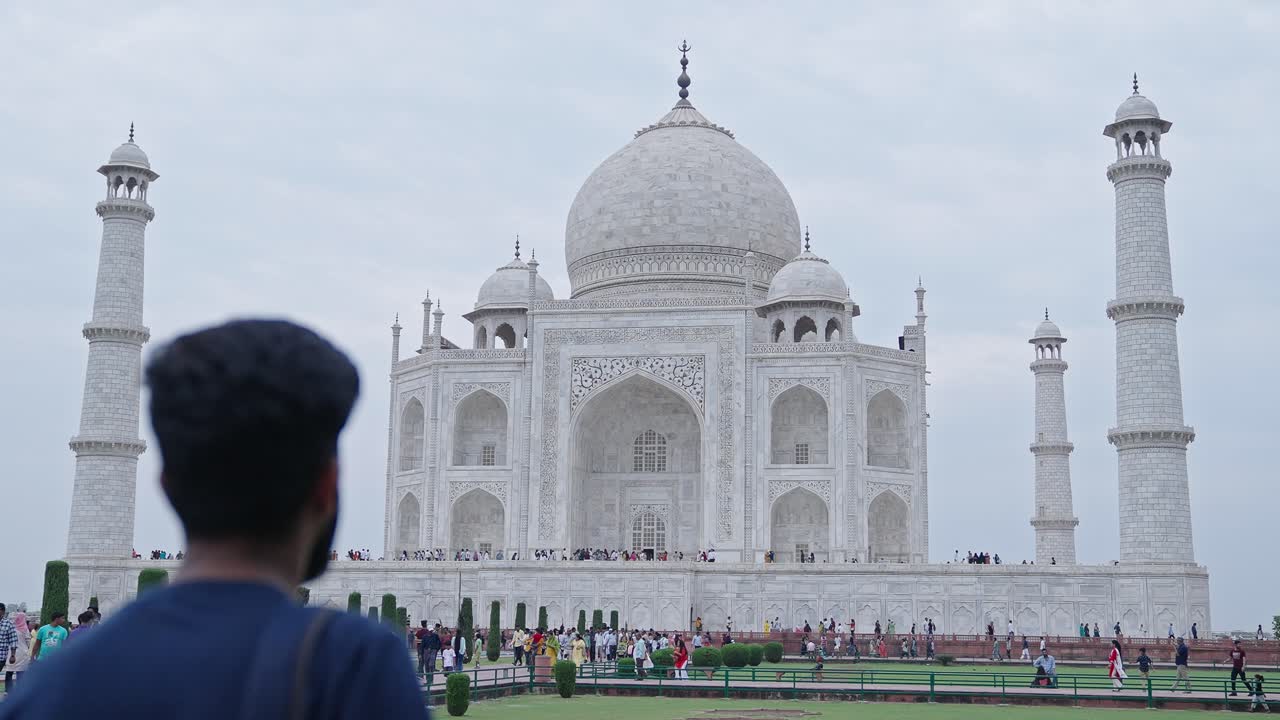 Premium stock video - Young man sight seeing taj mahal