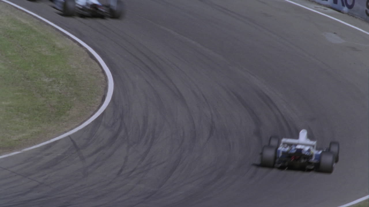 A race car speeds around a sharp turn Premium Stock Video Footage