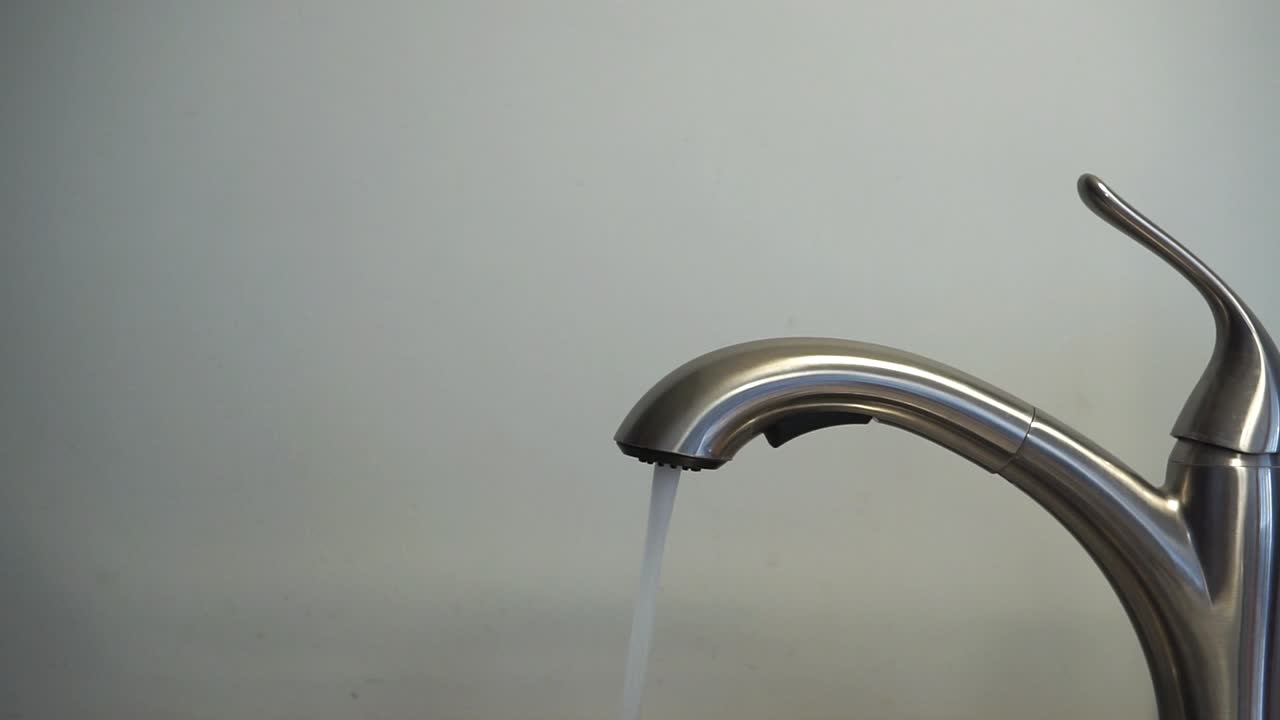 Premium stock video - Opening and closing faucet - water flow in sink