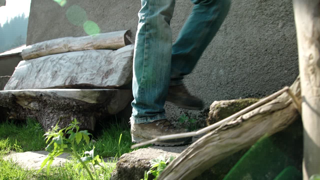 Anonymous Man Wearing Jeans And Boots Walking Up Stairs Of A Rural ...