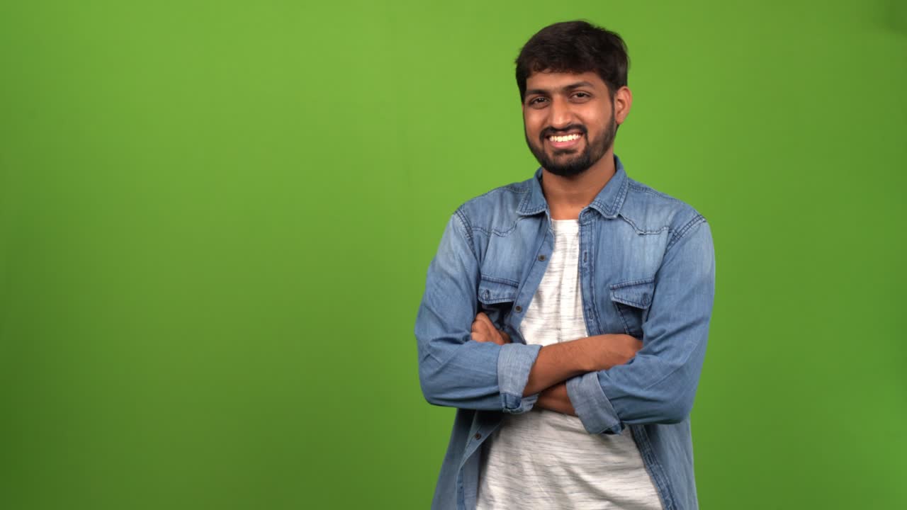 Asian Bearded Man With Toothy Grin Standing Tall In Front Of Green ...
