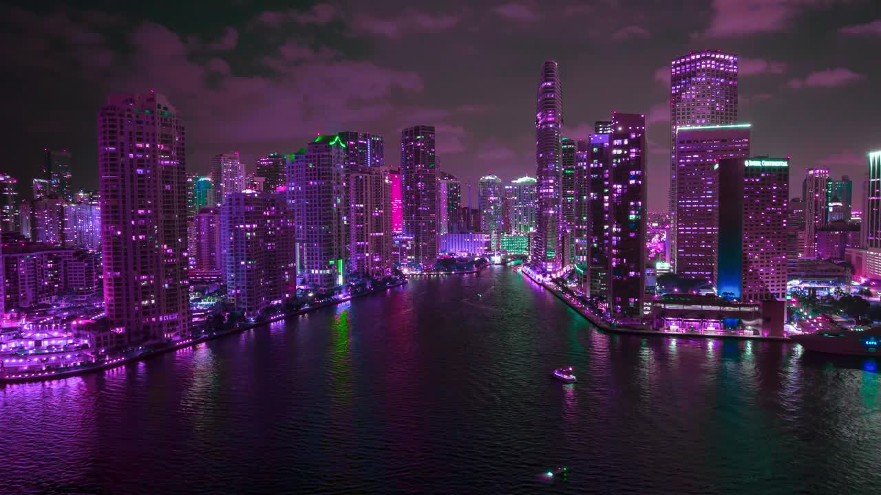 Downtown Miami at night with neon lights along the Miami River ...