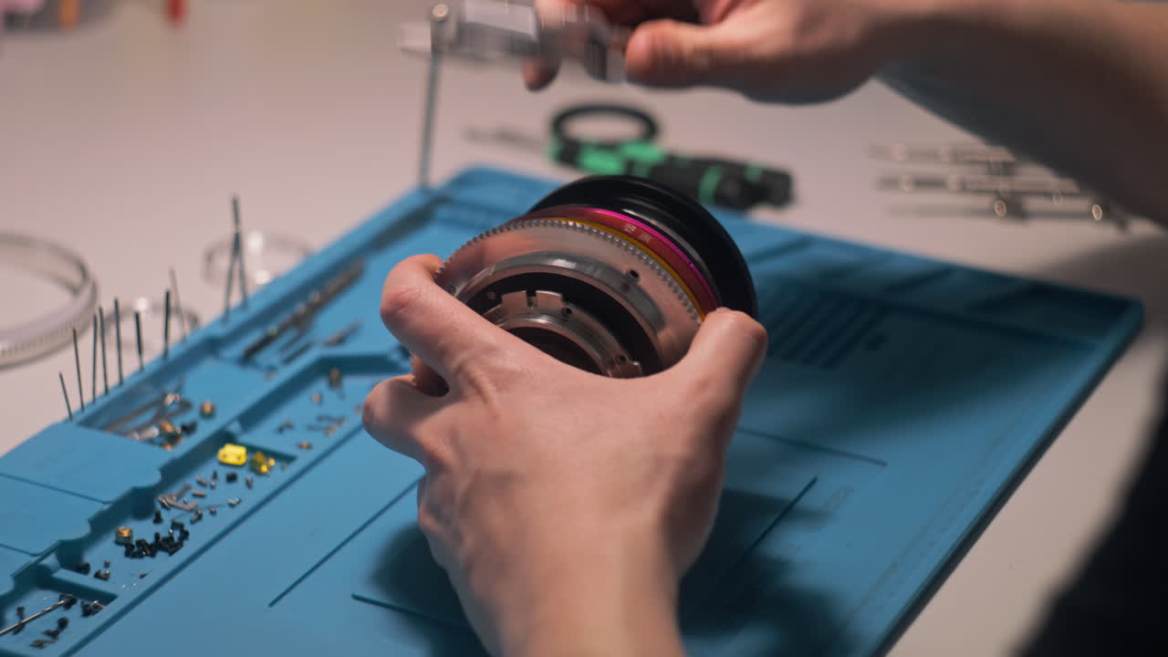 Premium stock video - Male technician takes lens measurements of cinema ...