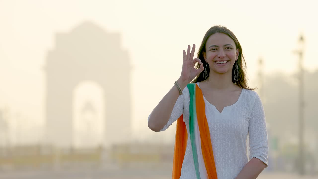 Happy Indian Girl Showing Okay Sign At India Gate In An Indian Wear ...