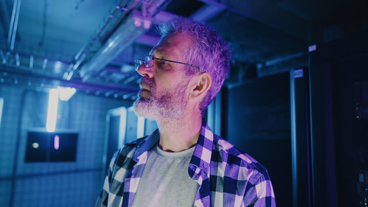 Technician working in a data center at night | Premium Stock Video Footage