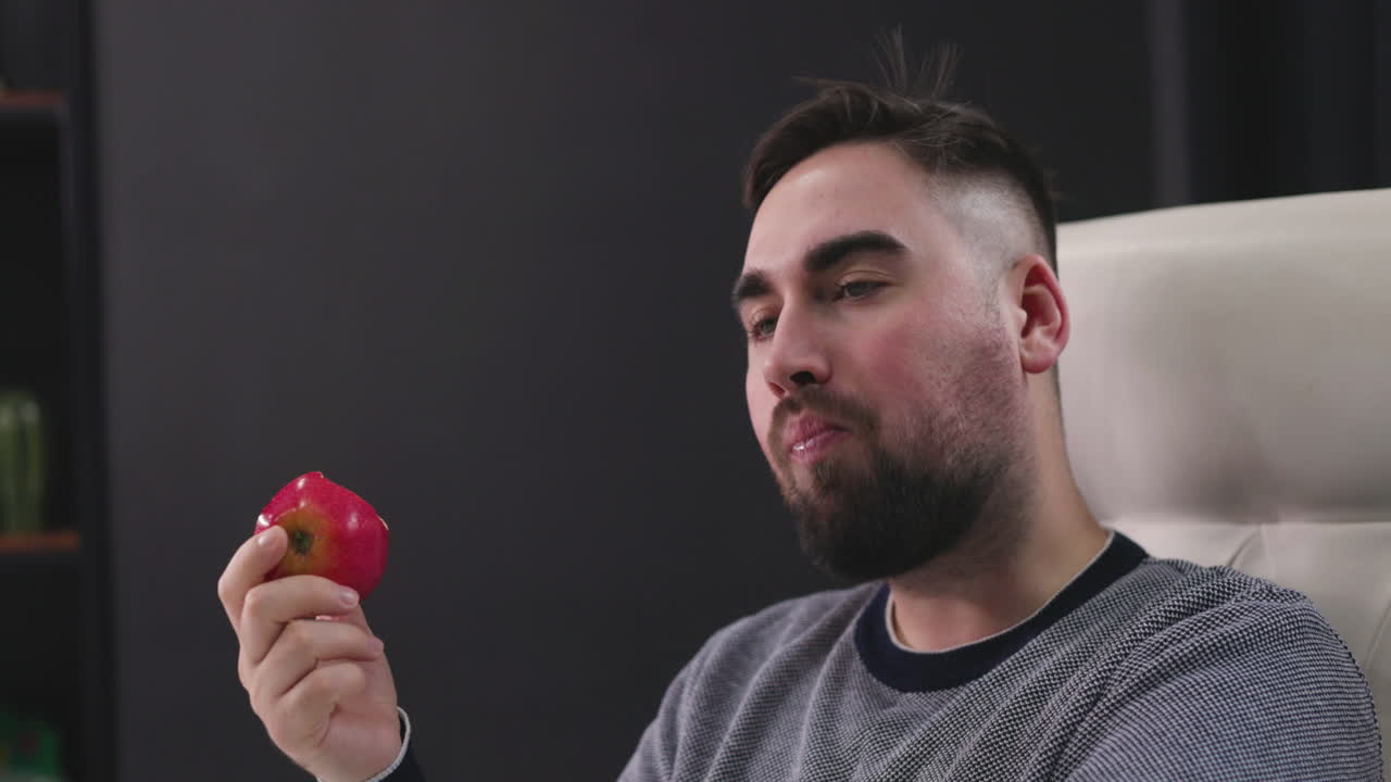 Hungry Man Sitting At Desk And Eating A Red Apple 1 | Free Stock Video ...