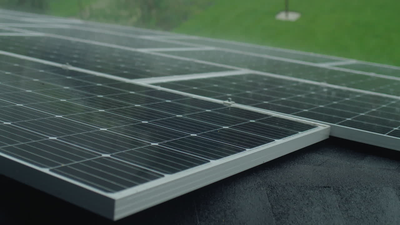 Premium stock video - Drops of rain fall on the solar panels on the ...