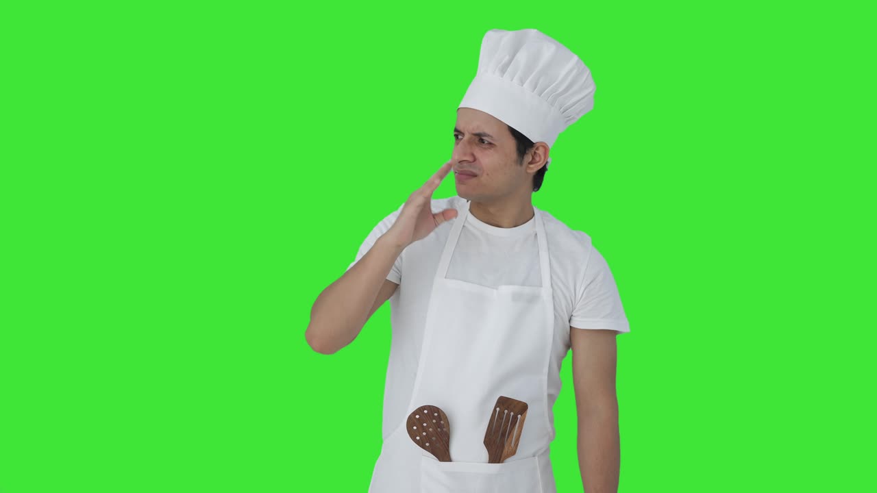 Indian professional chef disgusted by bad smell green screen Premium ...