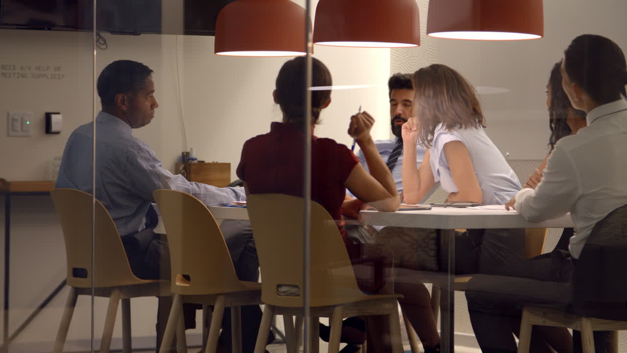 Corporate team at table in a meeting room cubicle, close up | Premium ...