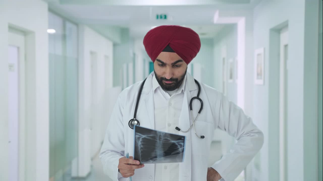 Premium stock video - Stressed sikh indian doctor checking x ray report