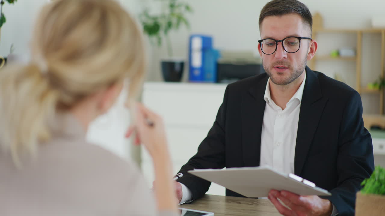Real Estate Agents Discuss Property Sale Report | Premium Stock Video ...