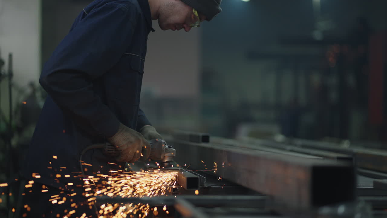 Premium stock video - Worker grinding a sheet of metal. professional ...