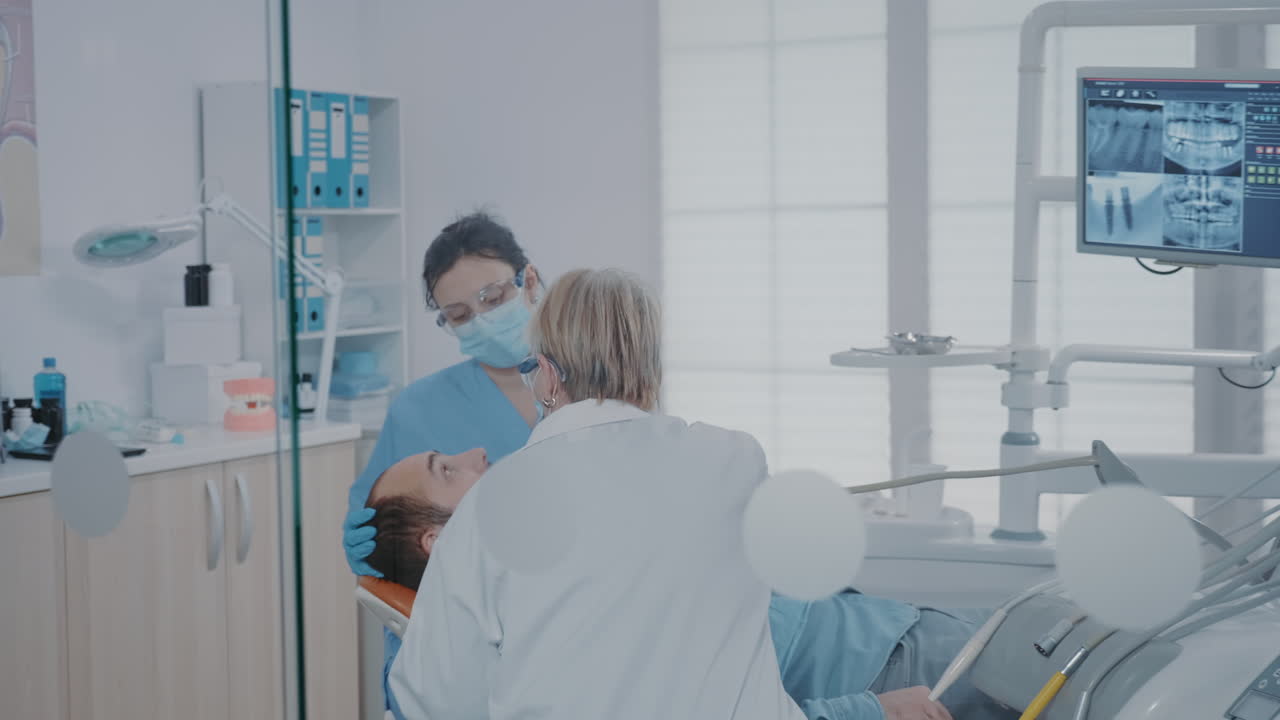 Nurse and stomatologist using drill tool to remove caries Premium Stock ...