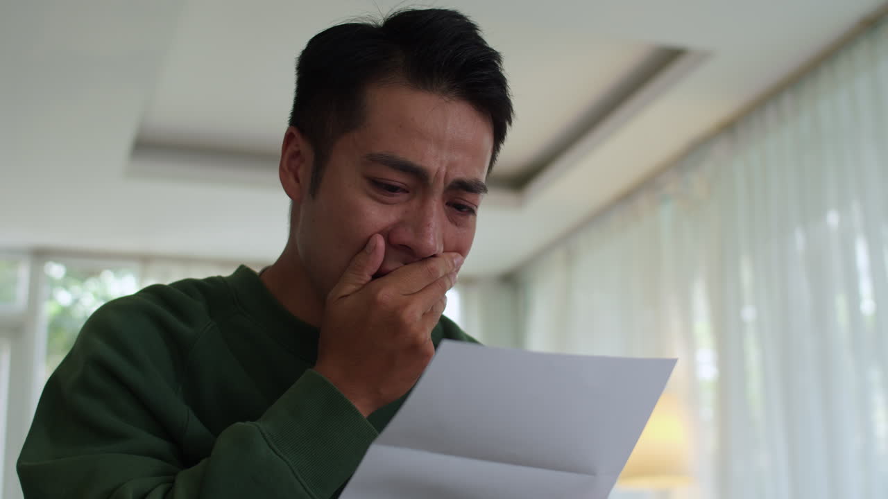 Sad man reading letter | Free Stock Video Footage