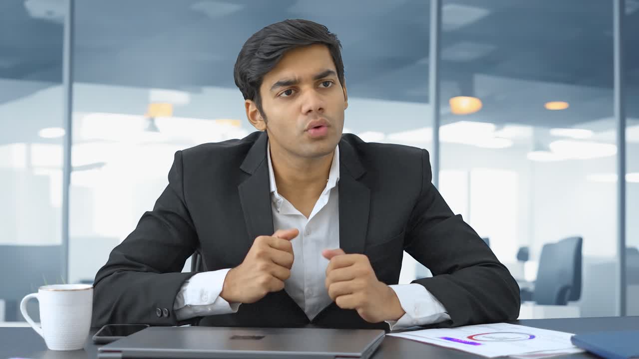 Premium stock video - Indian manager motivating employees in a meeting