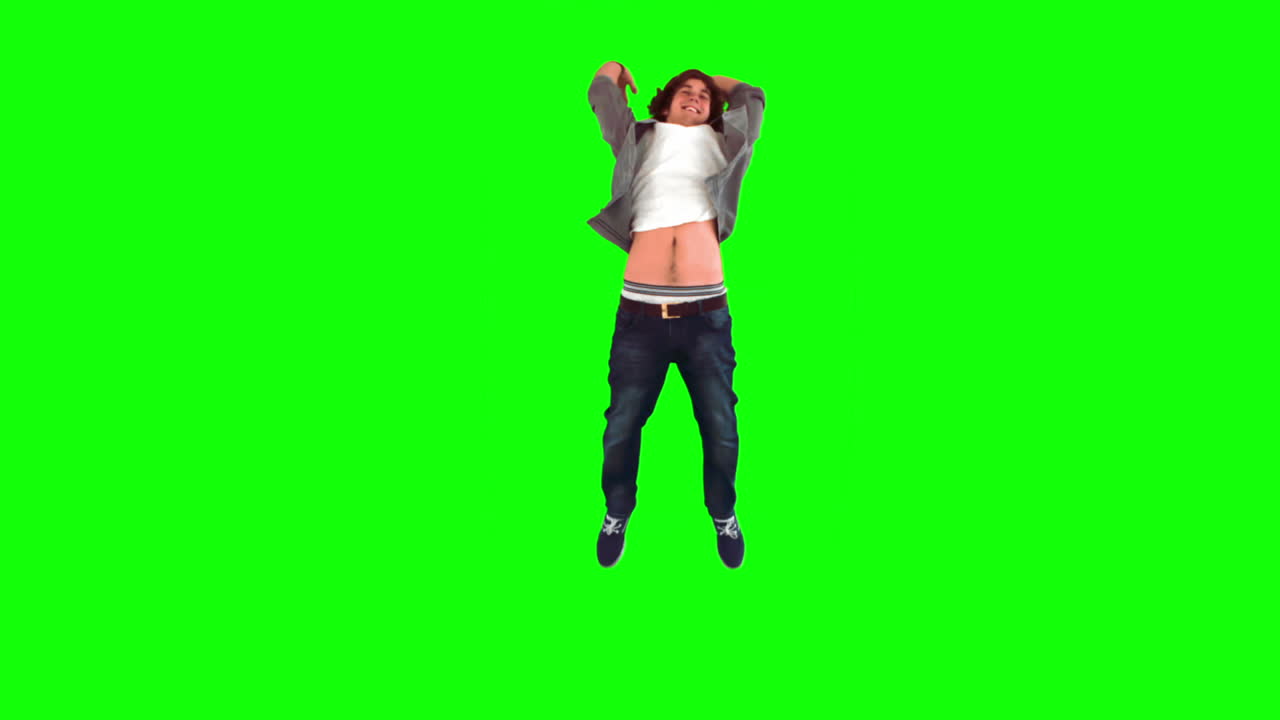 Premium stock video - Brown haired man in slow motion jumping