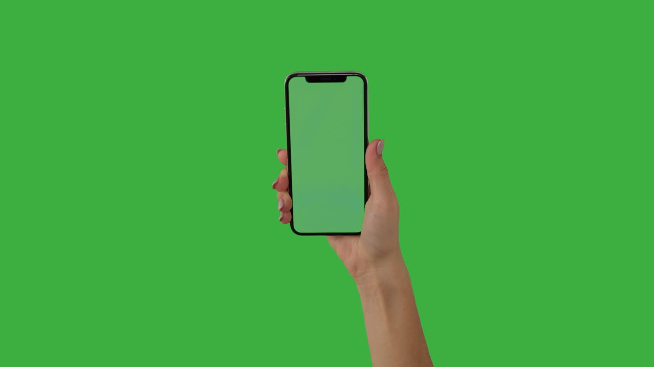 Hands pressing mobile phone touchscreen on green background | Premium ...