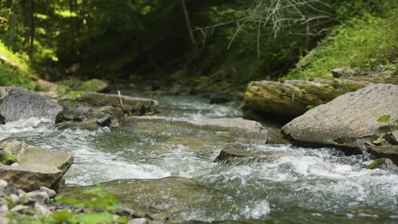 Premium stock video - Smooth stream water rolls across flat rocks ...