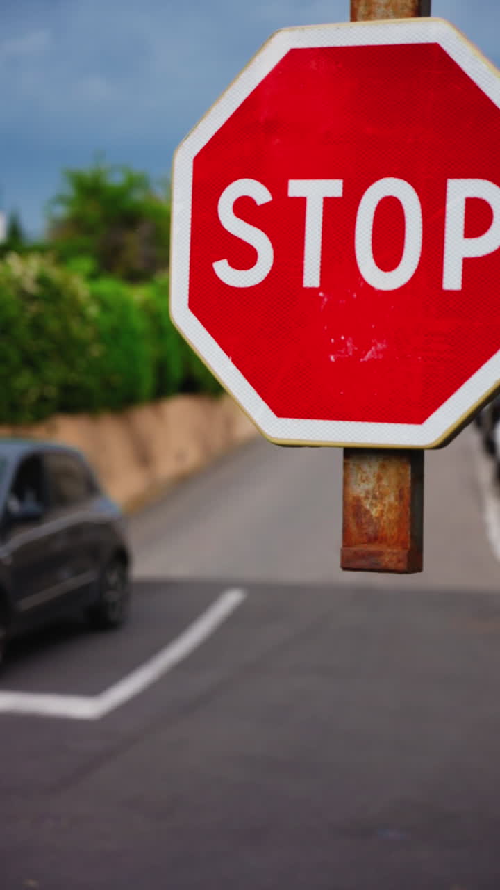 Close up of a stop sign with a blurred background of cars moving on the ...