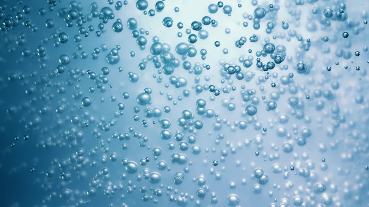 Many water bubbles in blue water close up, abstract water wave with ...