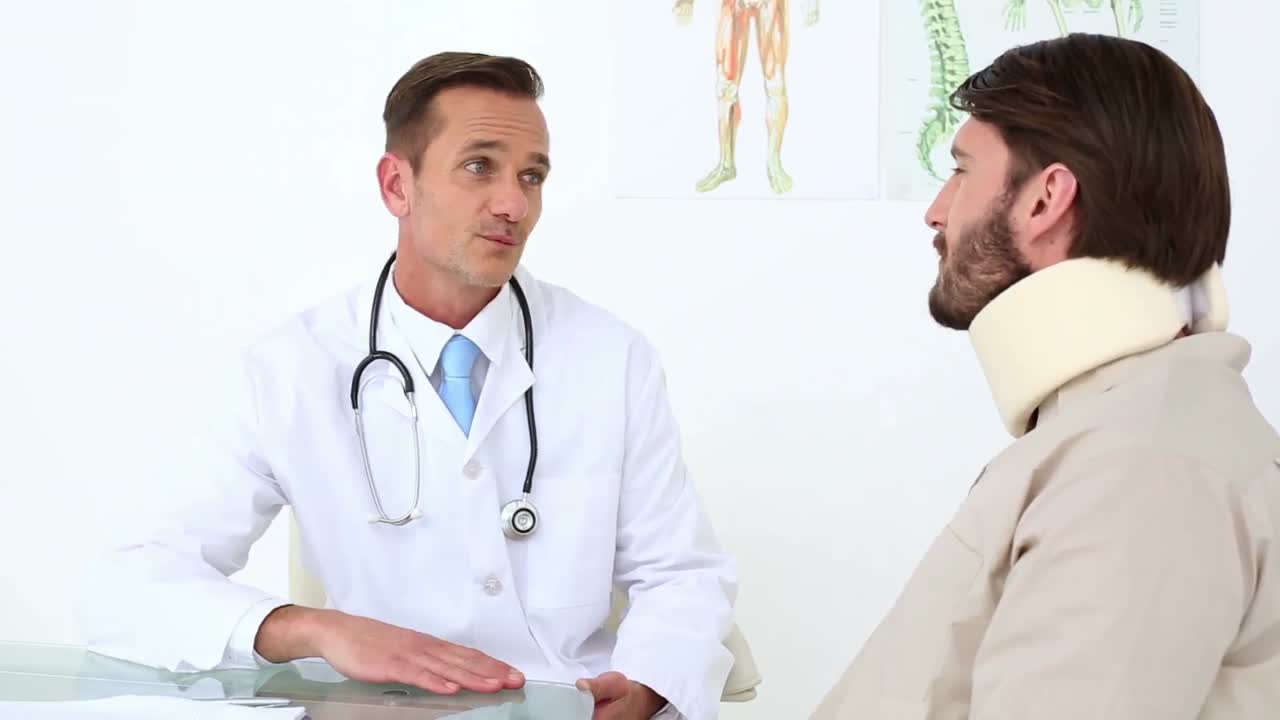 Doctor checking his patient in a neck brace | Premium Stock Video Footage