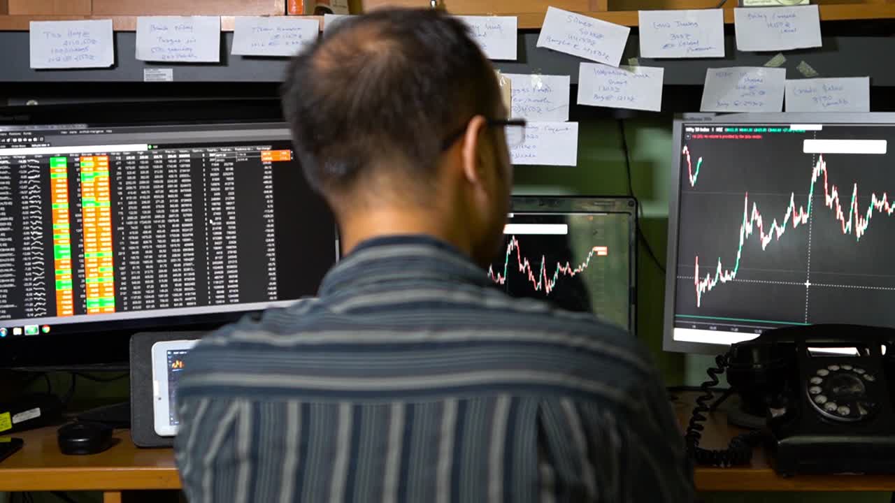 Premium stock video - Stock market broker watching stocks