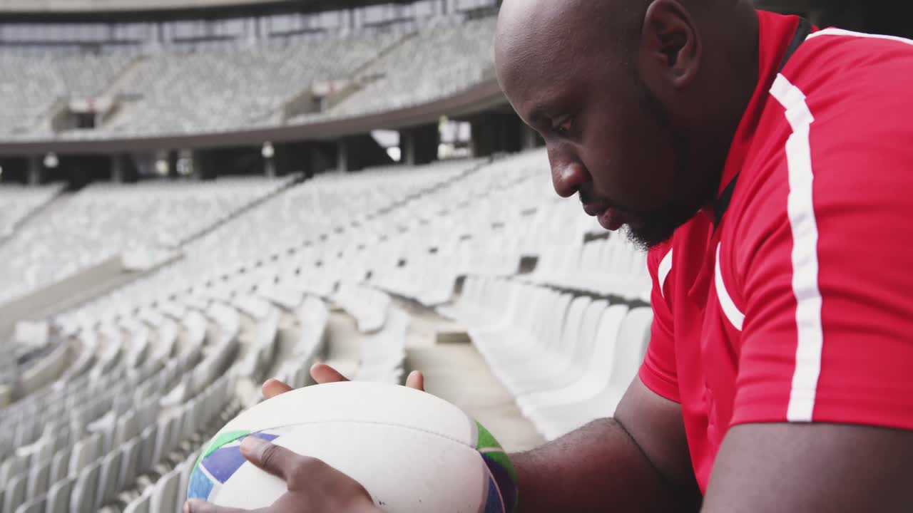 Male Rugby Player Sitting With Rugby Ball In Stadium 4k Free Stock ...