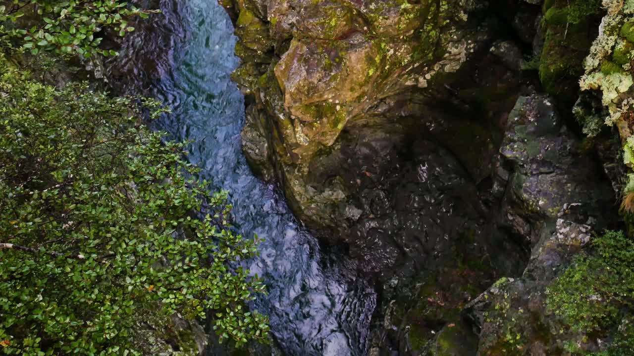 Premium stock video - Overhead tracking shot looking down into deep canyon