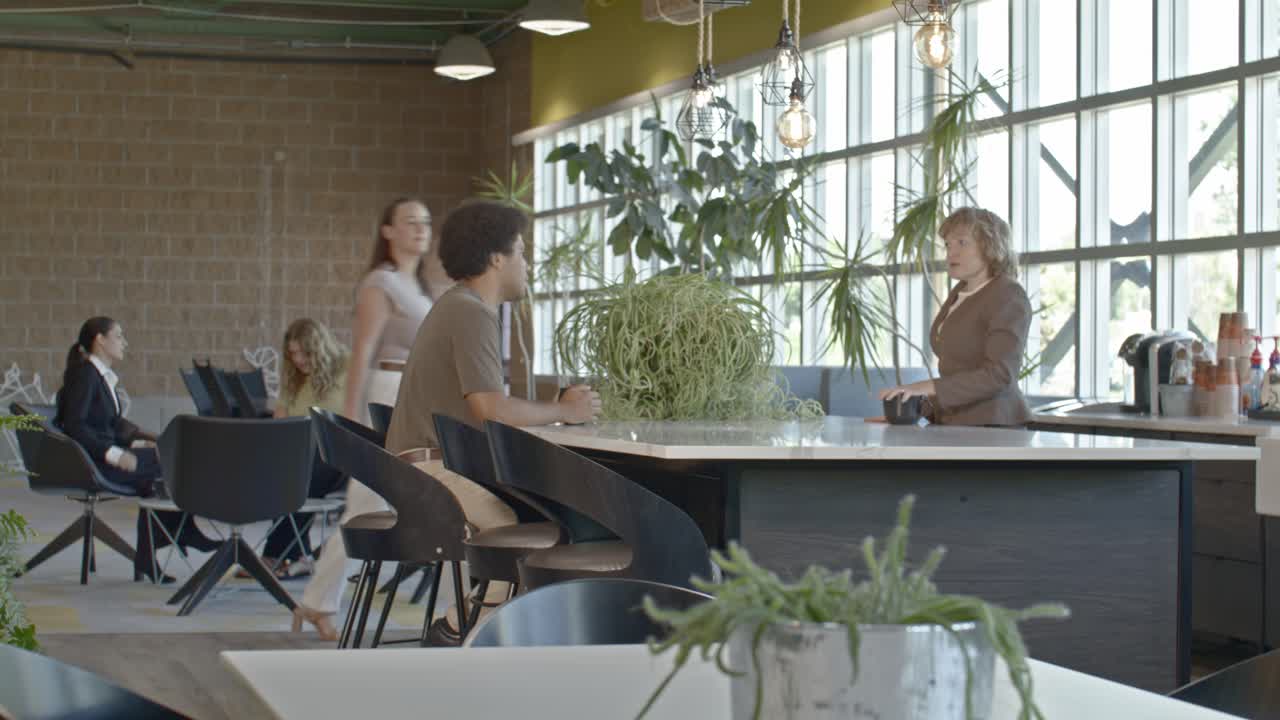 Premium stock video - Office setting with one senior citizen woman and ...