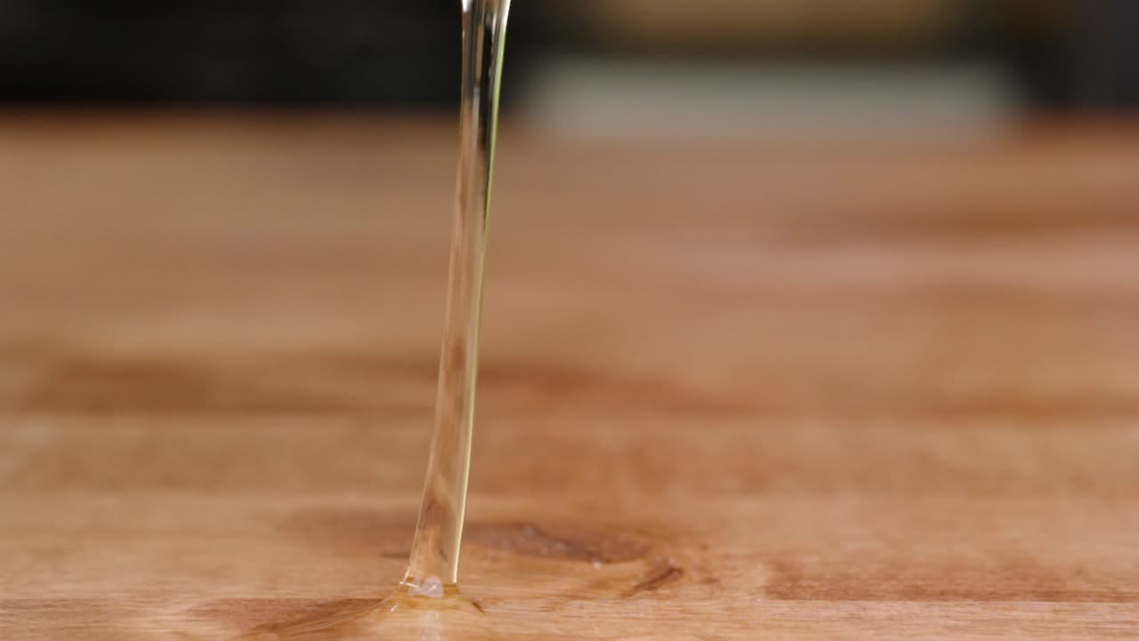 Premium stock video - Brown egg being cracked on butcher block and ...