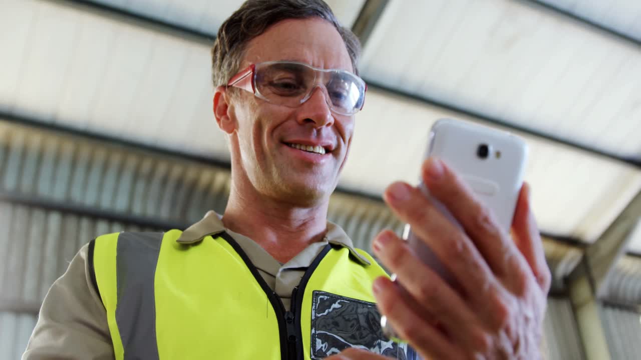 Worker using mobile phone Premium Stock Video Footage