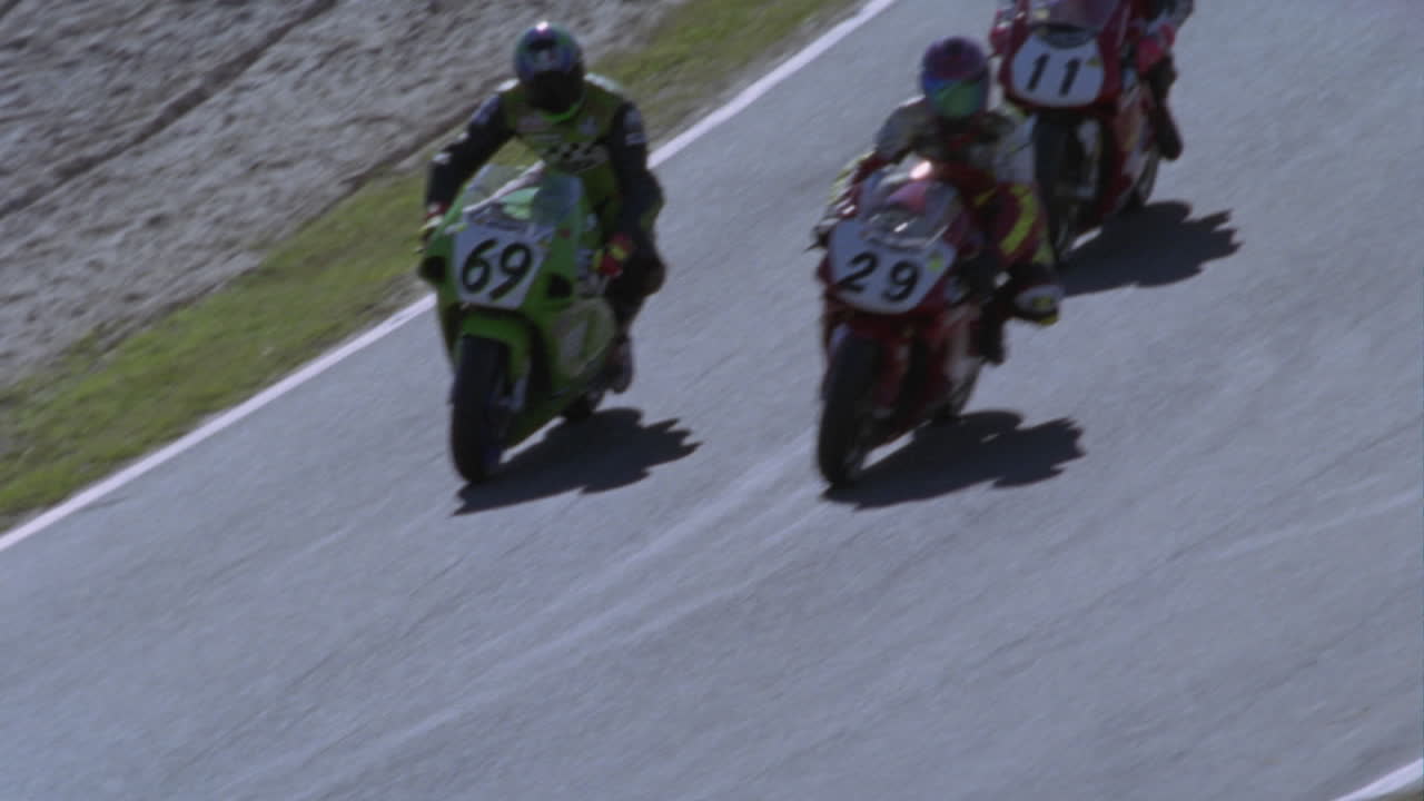 Premium stock video - Motorcyclists race around a track 1