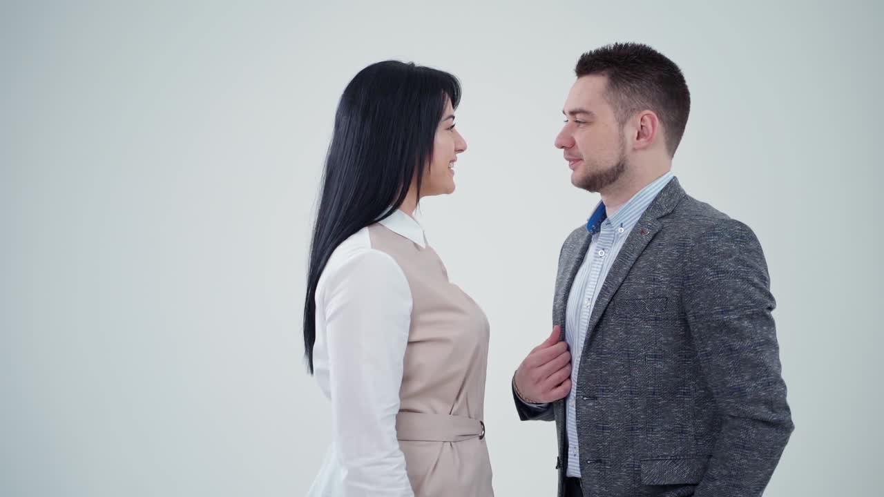 Portrait of a lovely couple. Handsome man in suit looking at a pretty ...