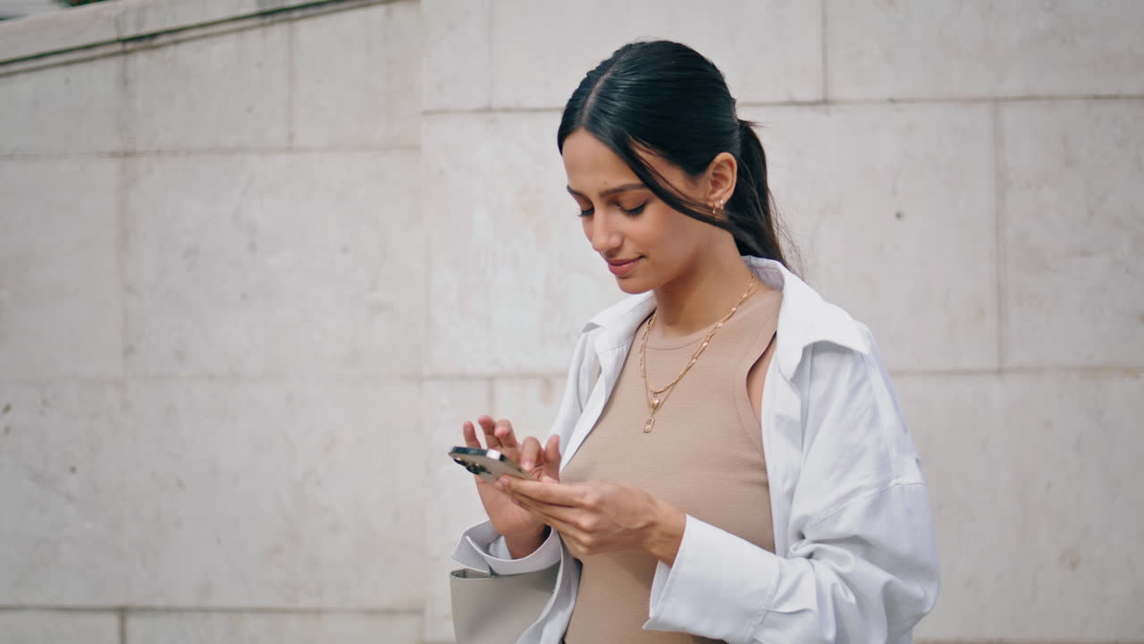 Happy girl messaging smartphone street vertical closeup. smiling lady ...