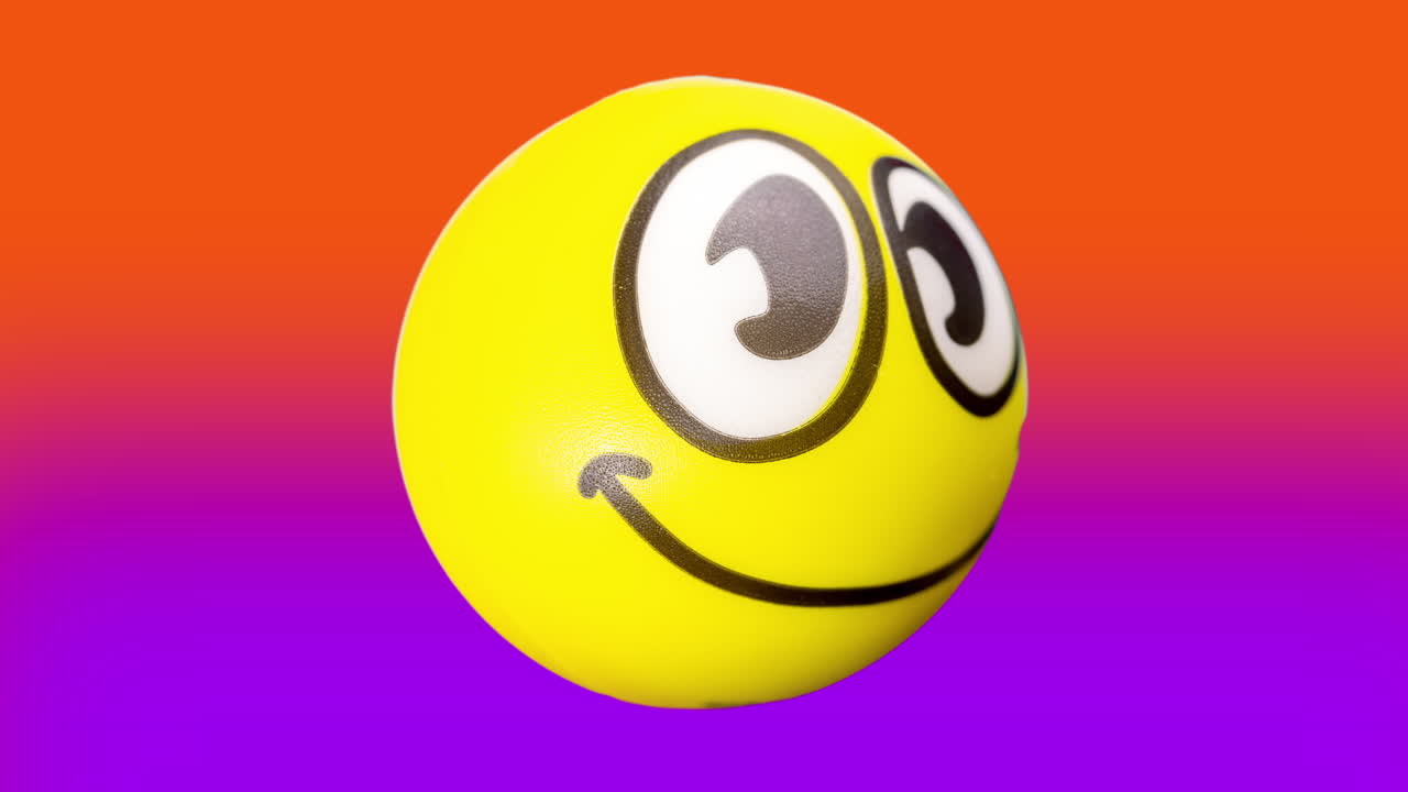 Premium stock video - Smiley emoji face turning