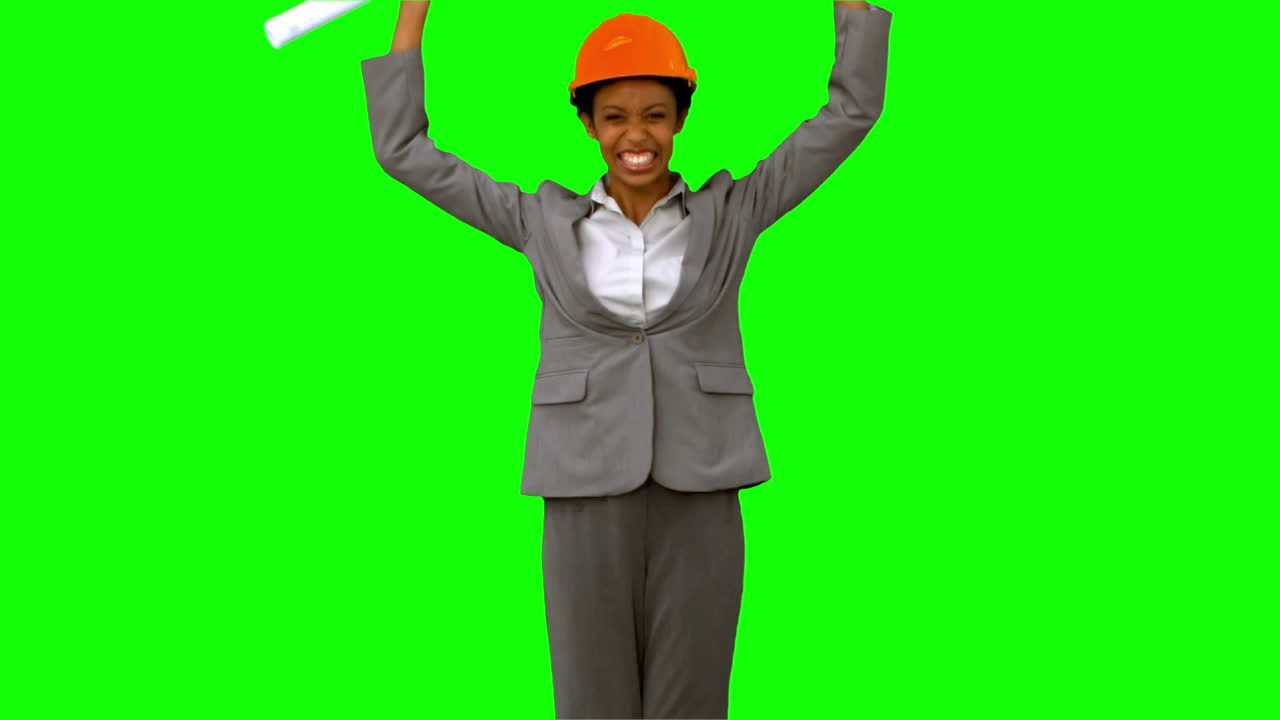 Premium stock video - Architect raising arms on green screen