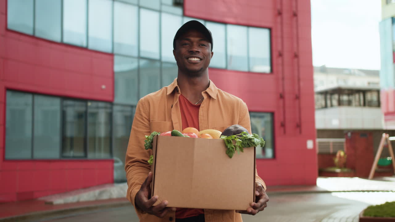 Free stock video - Courier holding box outdoors